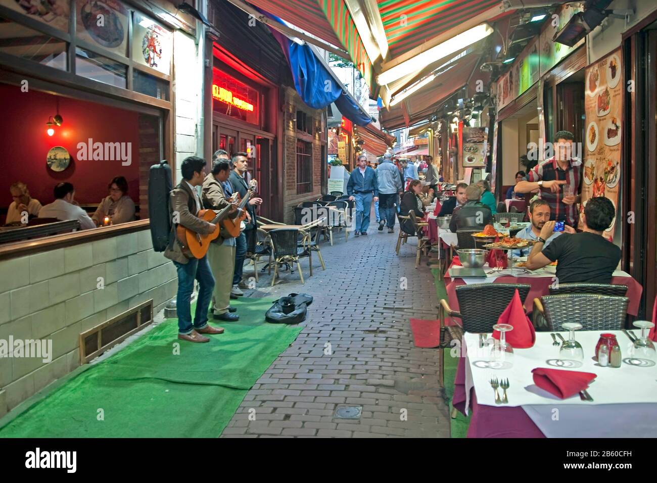 Belgium, Brussels, people in a street with a bars and restaurants ...