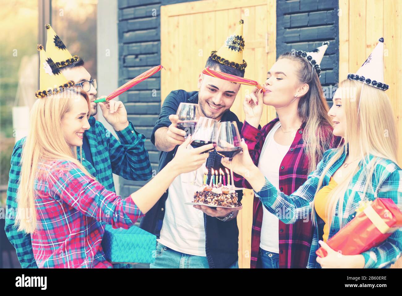 Happy excited friends having fun outdoor at birthday party celebrating ...