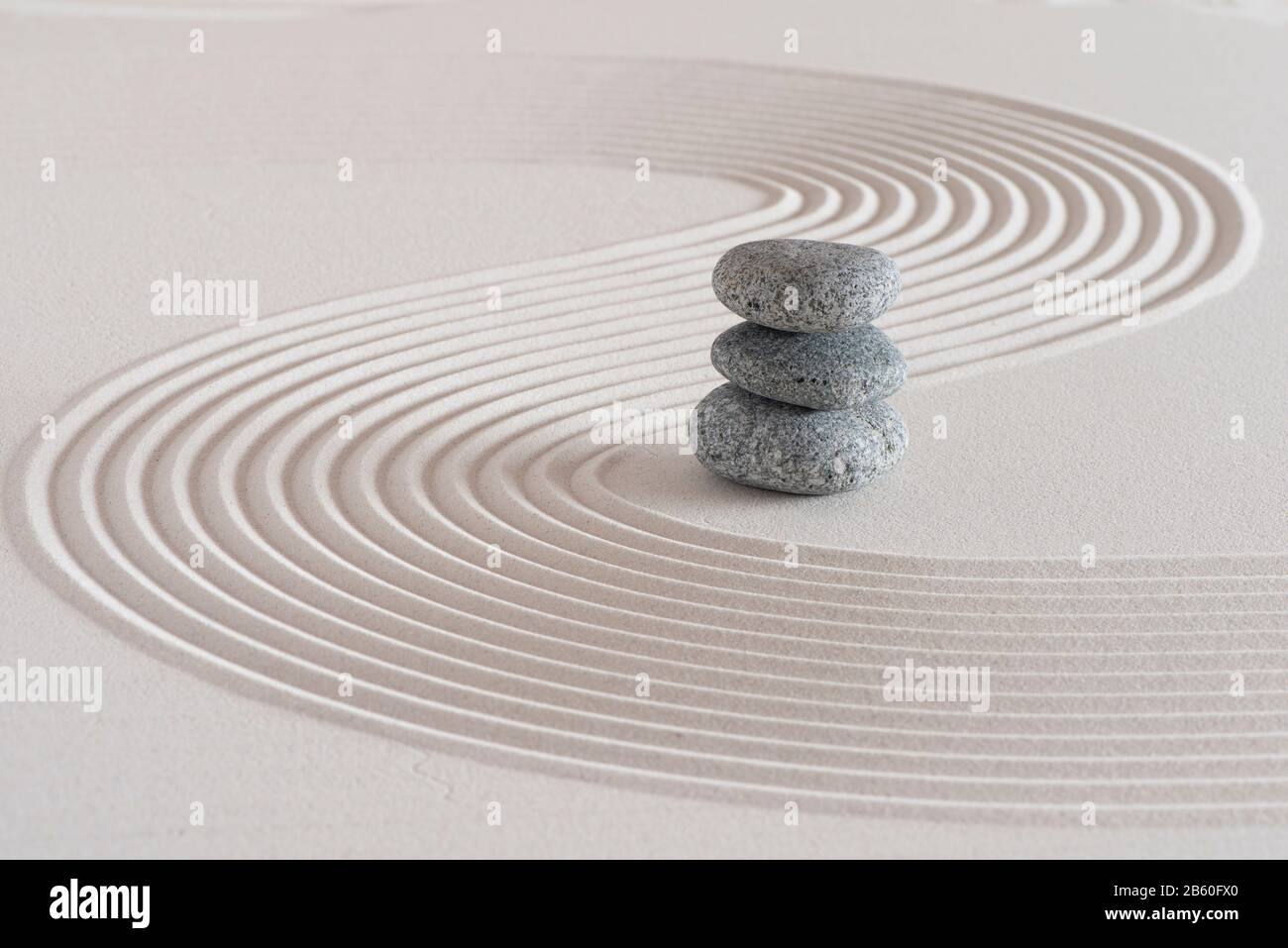 Japanese zen garden with stone in textured white sand Stock Photo - Alamy