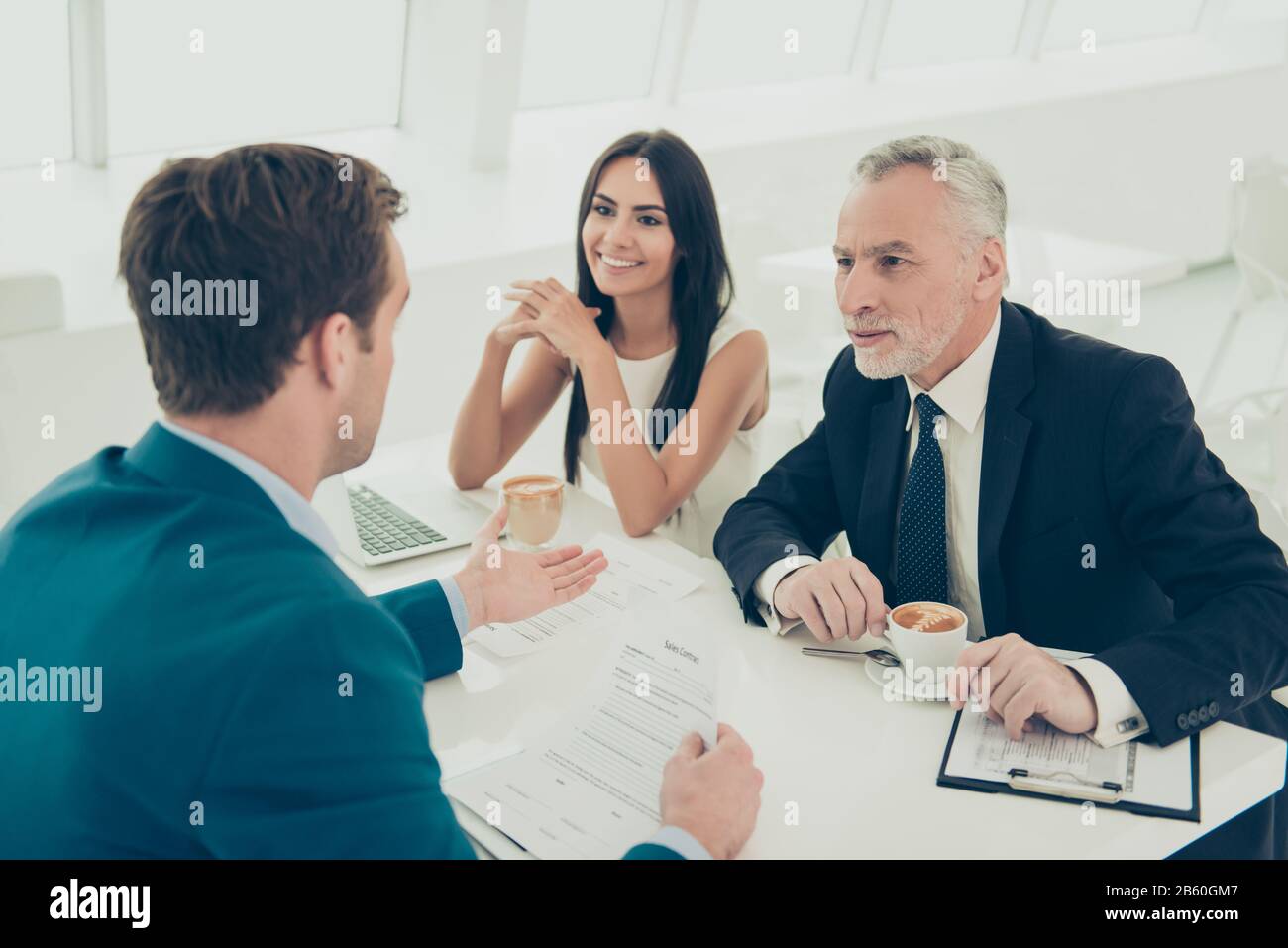 Two happy colleagues on meeting with their business partner Stock Photo ...