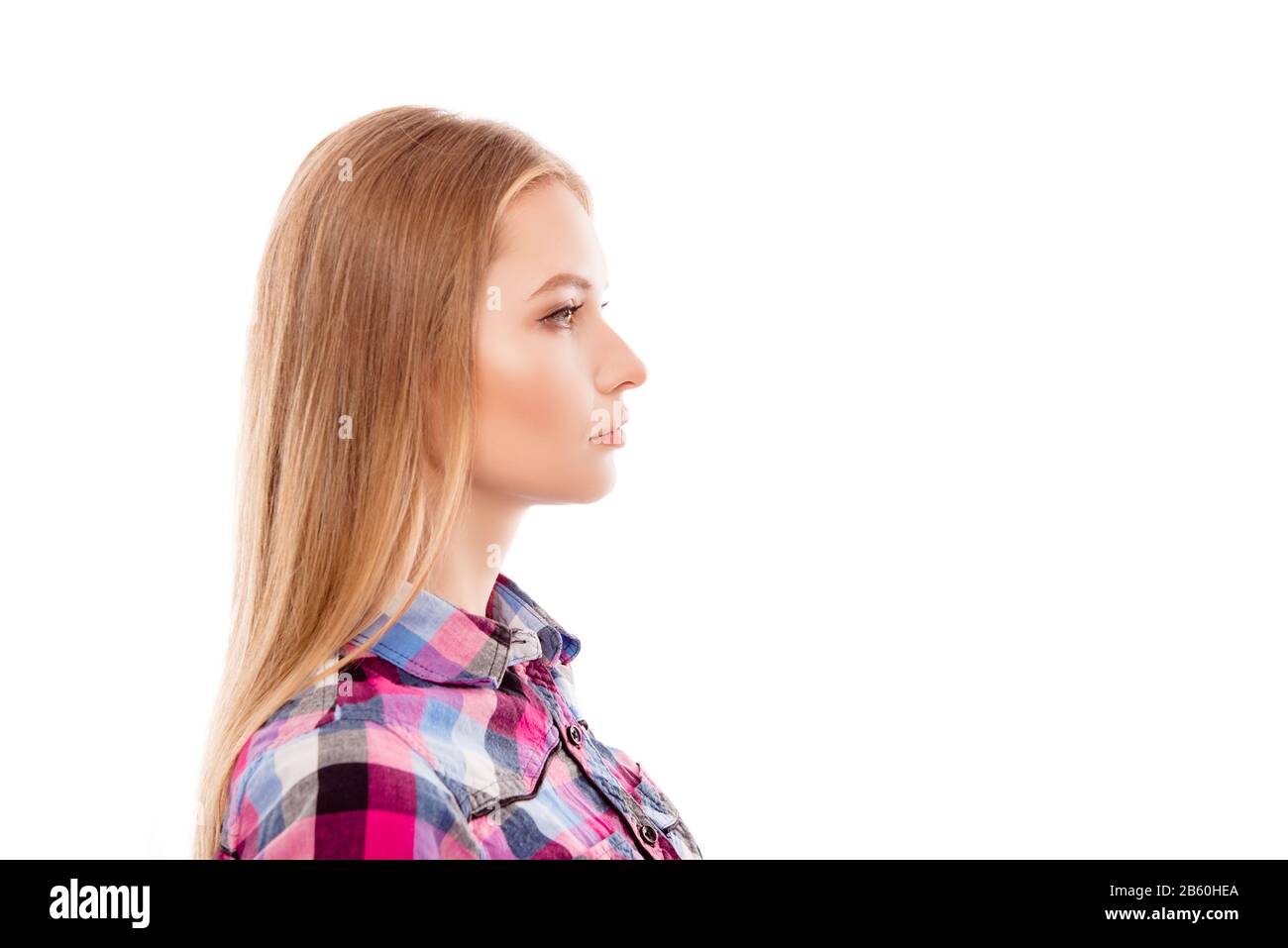 Side-face portrait of a confident woman isolated on white background ...
