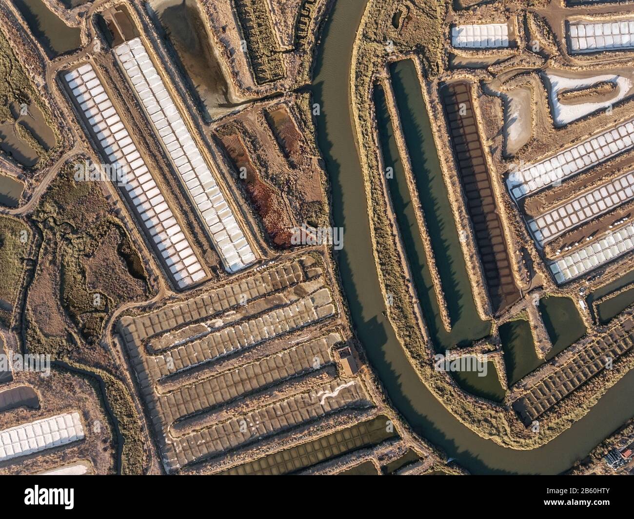 Aerial. Textured fields of swampy salt lakes. Salines of Portugal. Vila ...