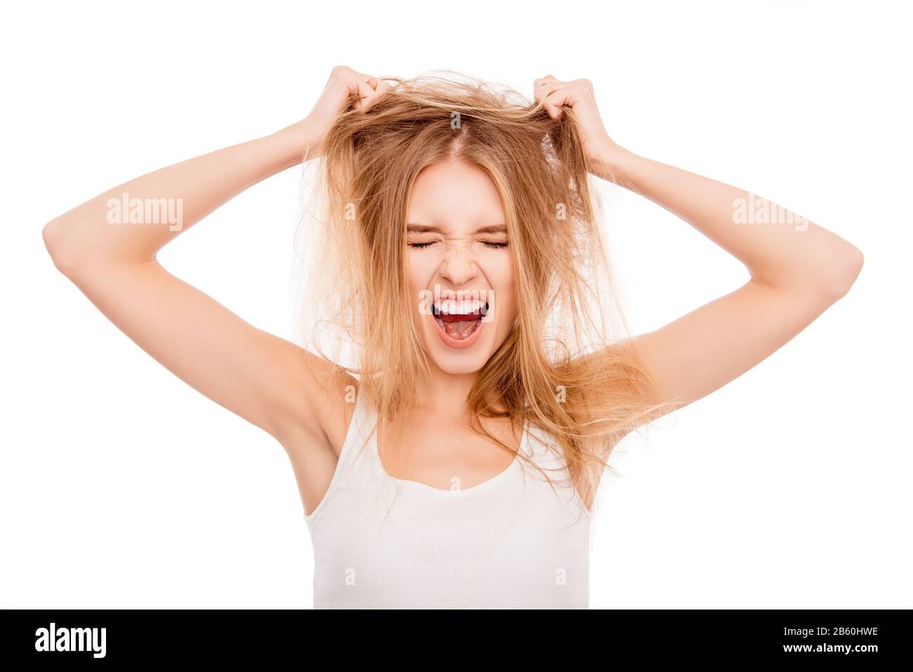 Sad pretty girl holding her damaged hair and shouting Stock Photo - Alamy