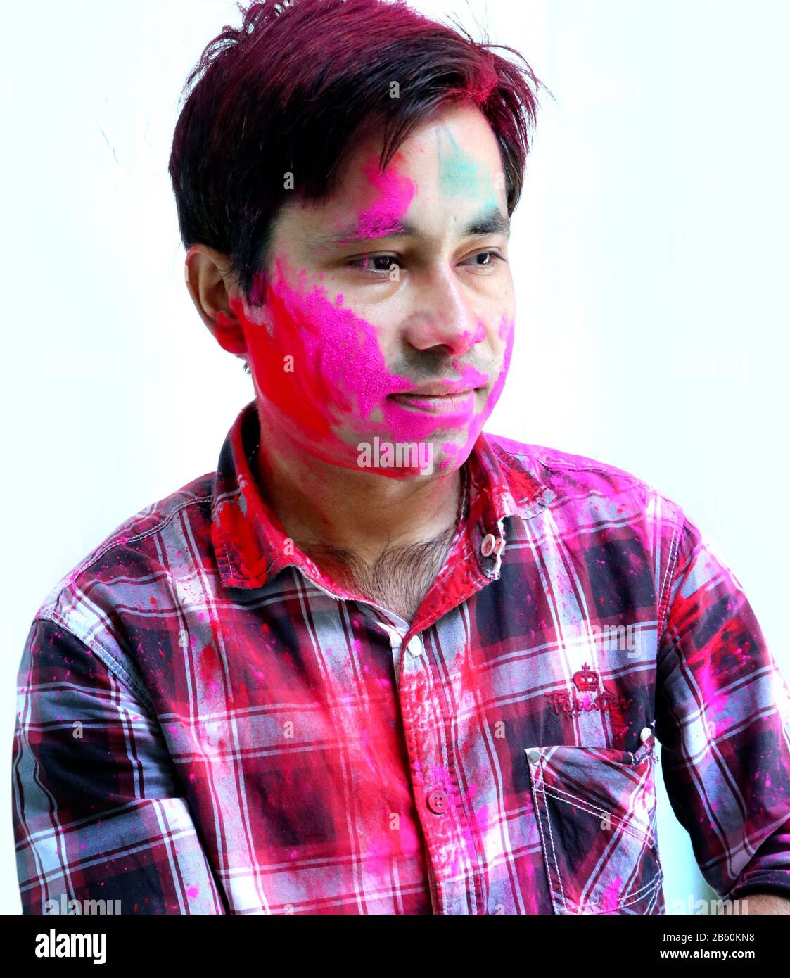 Closeup shot of Indian young man covered with multi color dry paint at ...