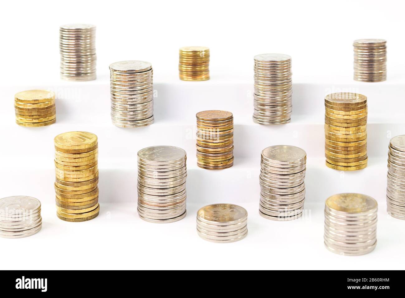 Stacks of various metal coins on a white staircase Stock Photo - Alamy