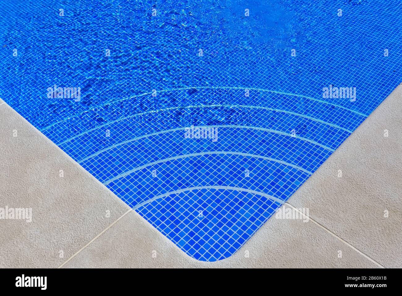 Steps under the blue water in the pool. Close-up Stock Photo - Alamy