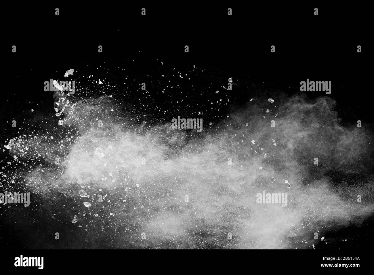White powder explosion isolated on black background.White dust ...