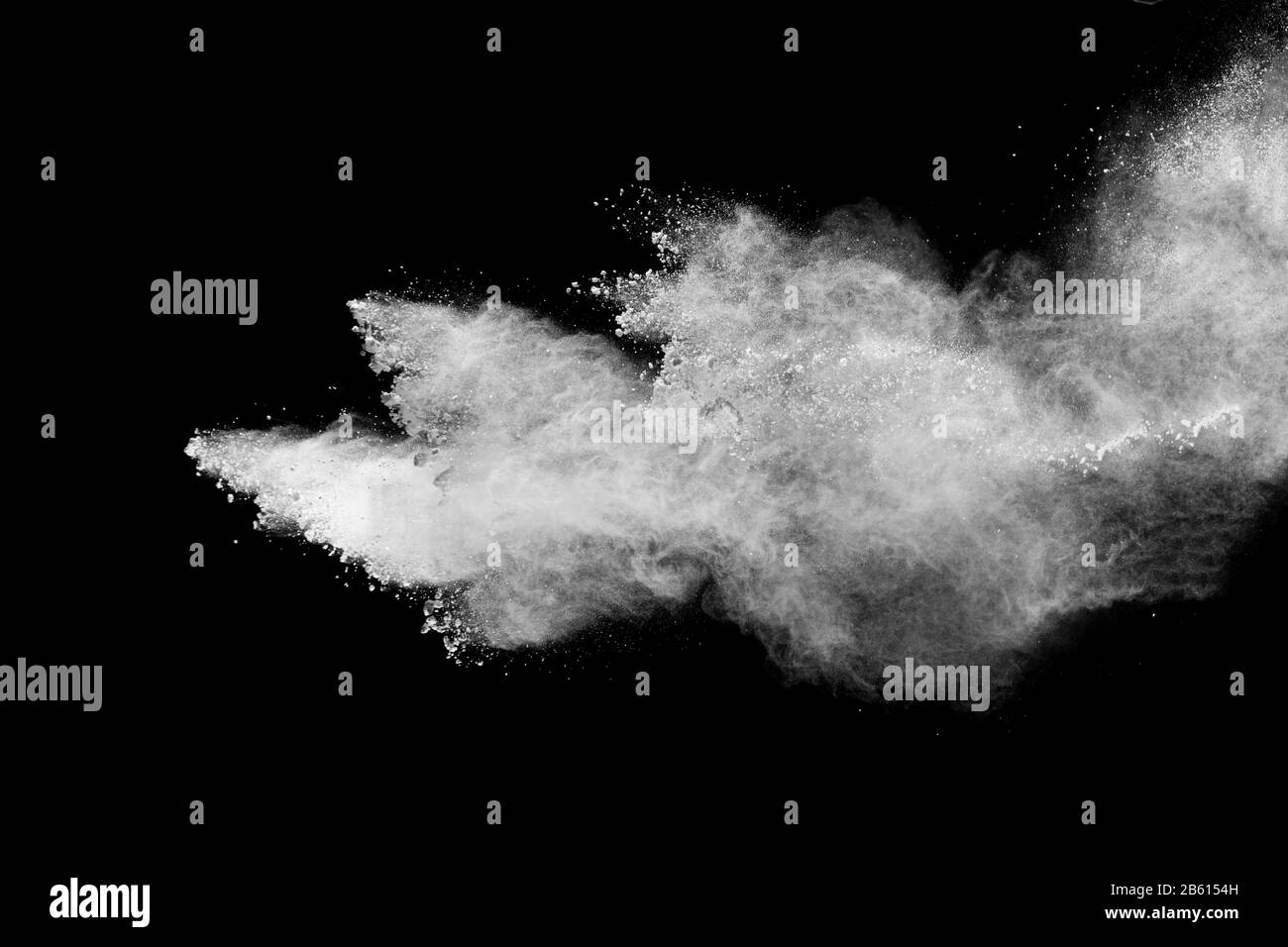 White powder explosion isolated on black background.White dust ...