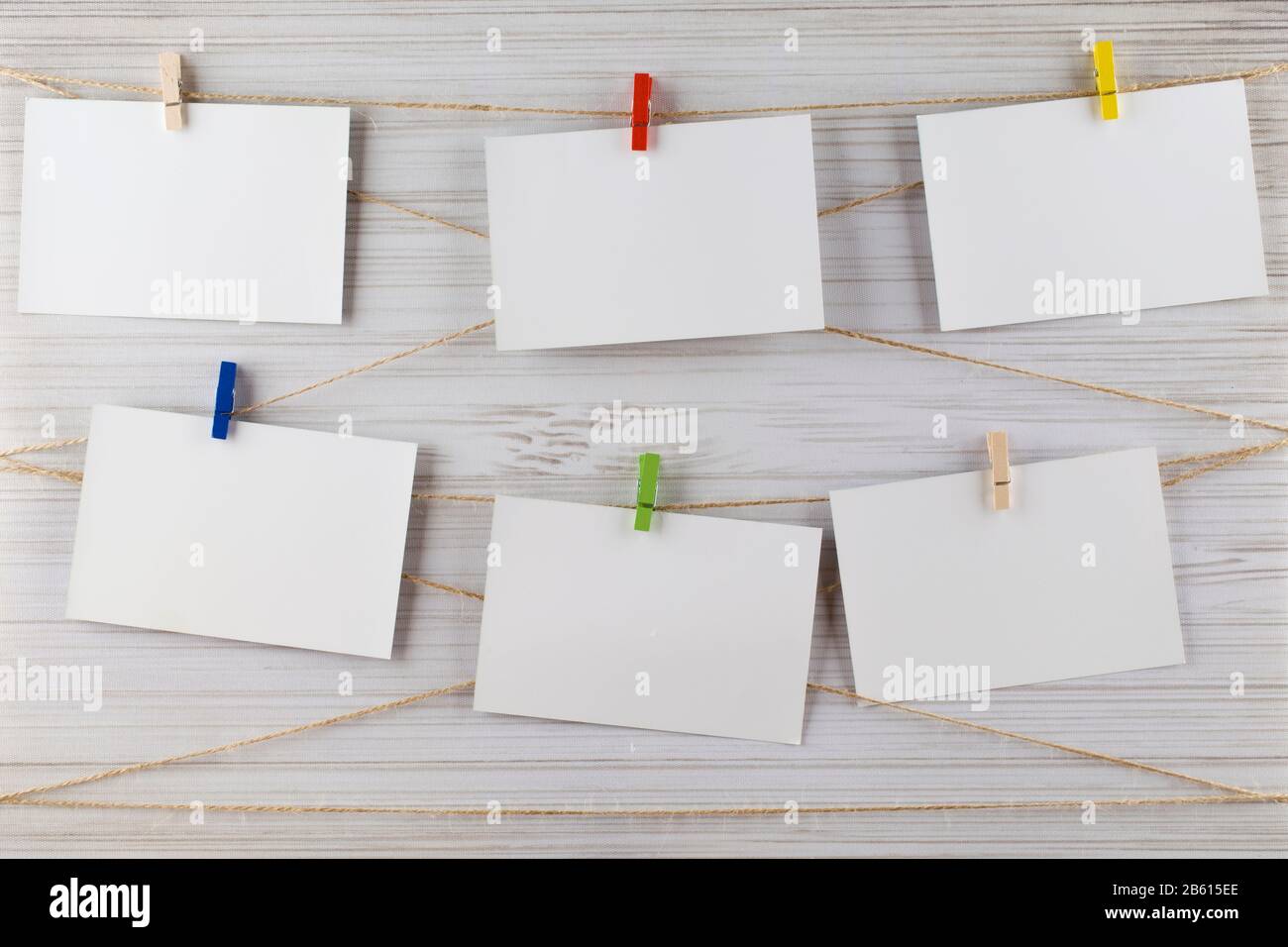 Empty colored paper sheets for notes, frames that hang on a rope with ...