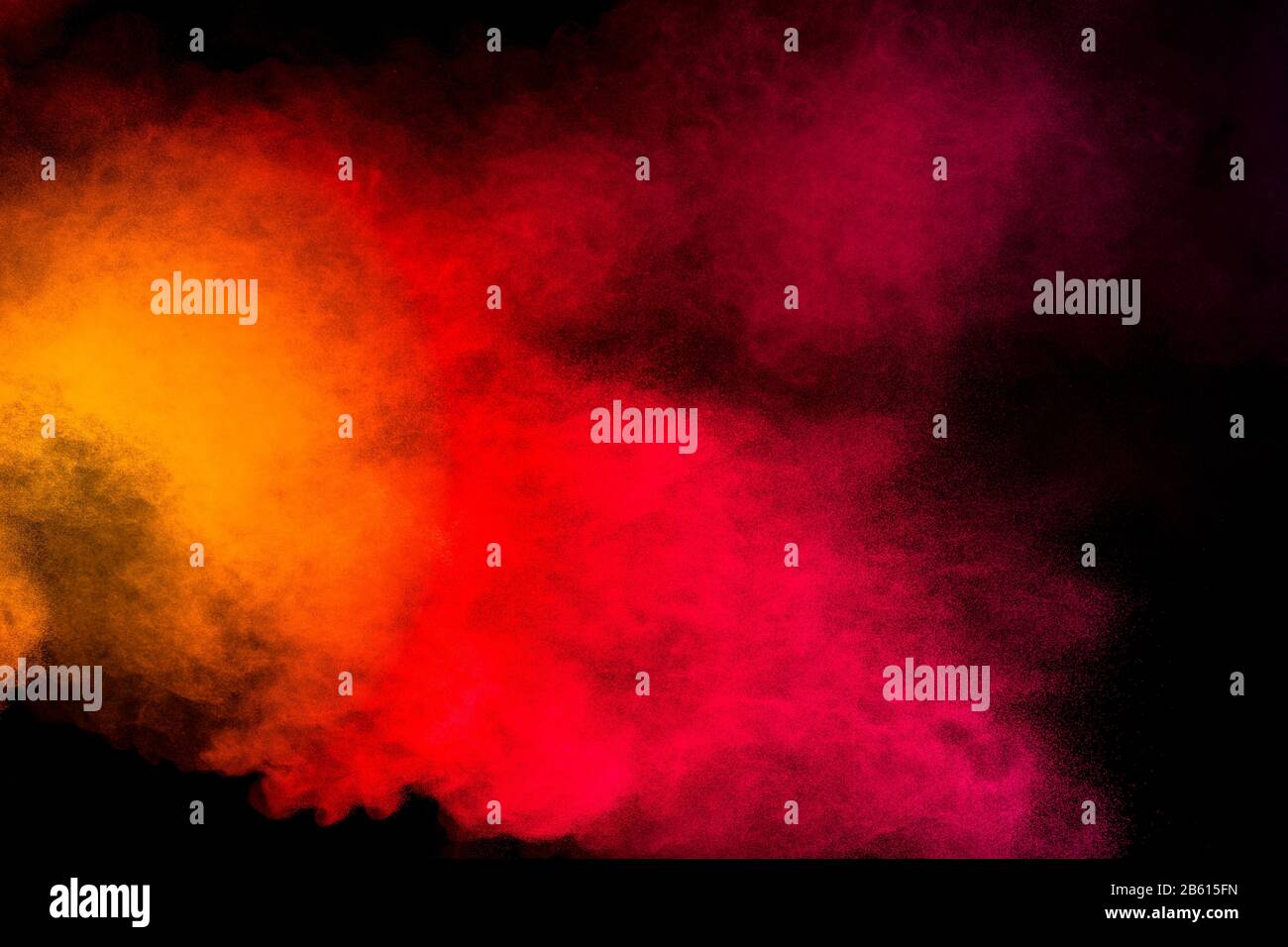 Abstract yellow orange powder explosion on black background.Freeze ...