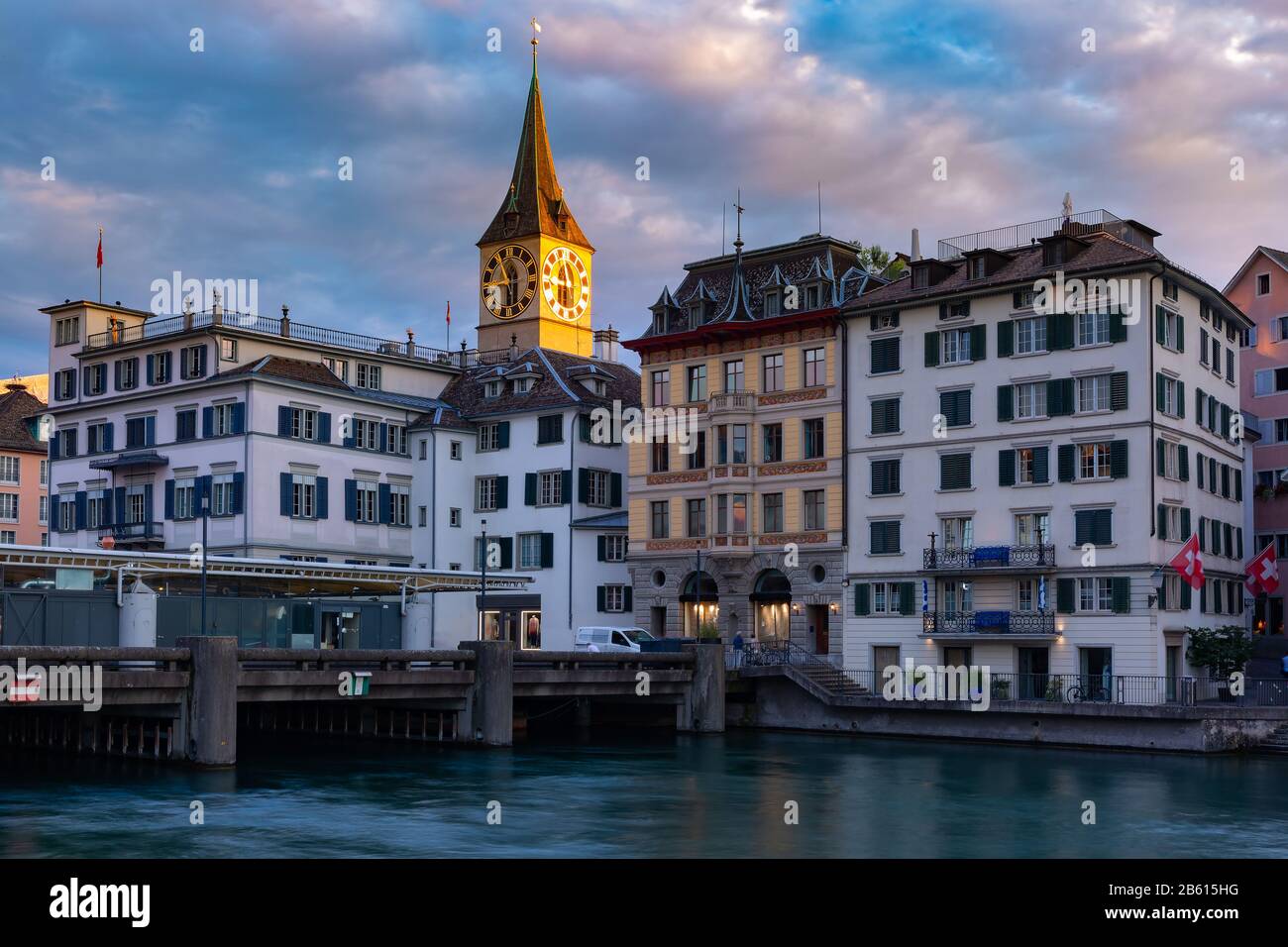 Sunny church of St Peter and medieval houses along river Limmat at ...