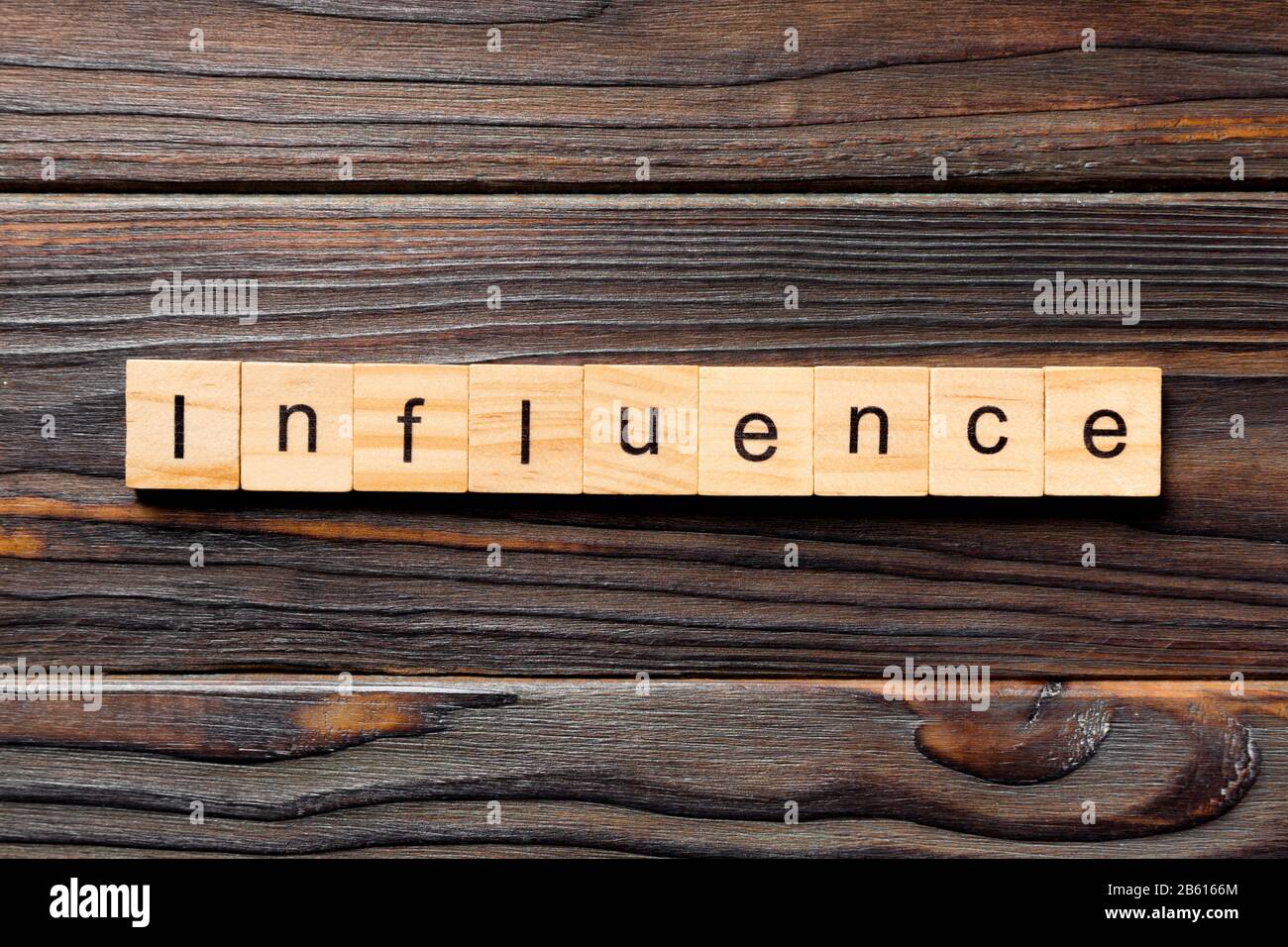 influence word written on wood block. influence text on table, concept ...