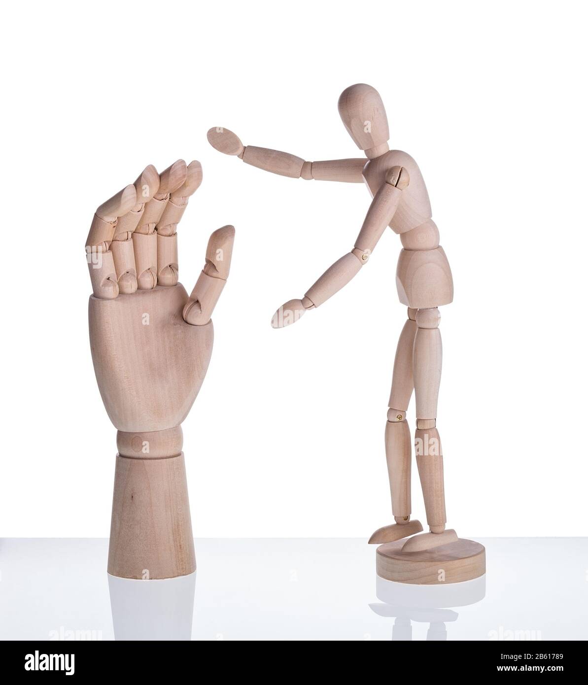 Wooden dummy and a symbol of the hand prosthesis. On a white background ...