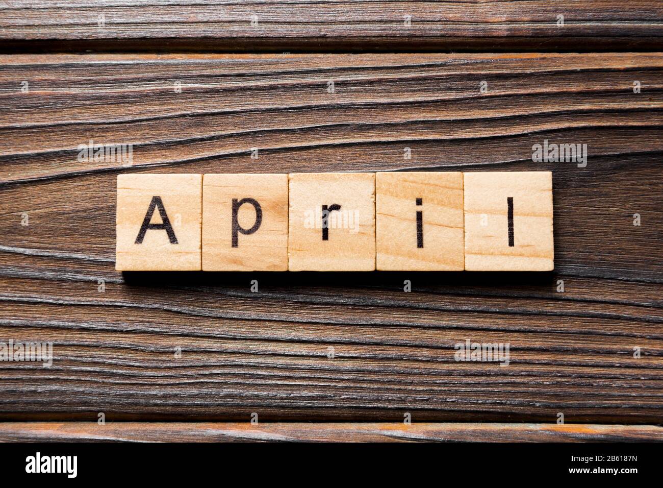 April word written on wood block. April text on wooden table for your ...
