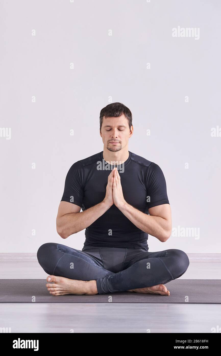 Man yoga class. Black wear. Calm relax pose Stock Photo - Alamy