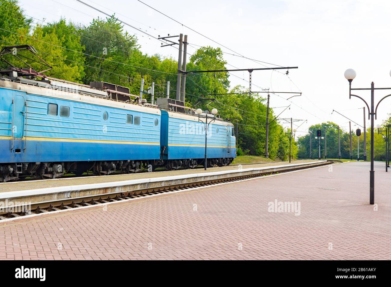 Old blue passenger train at the railway station Stock Photo - Alamy
