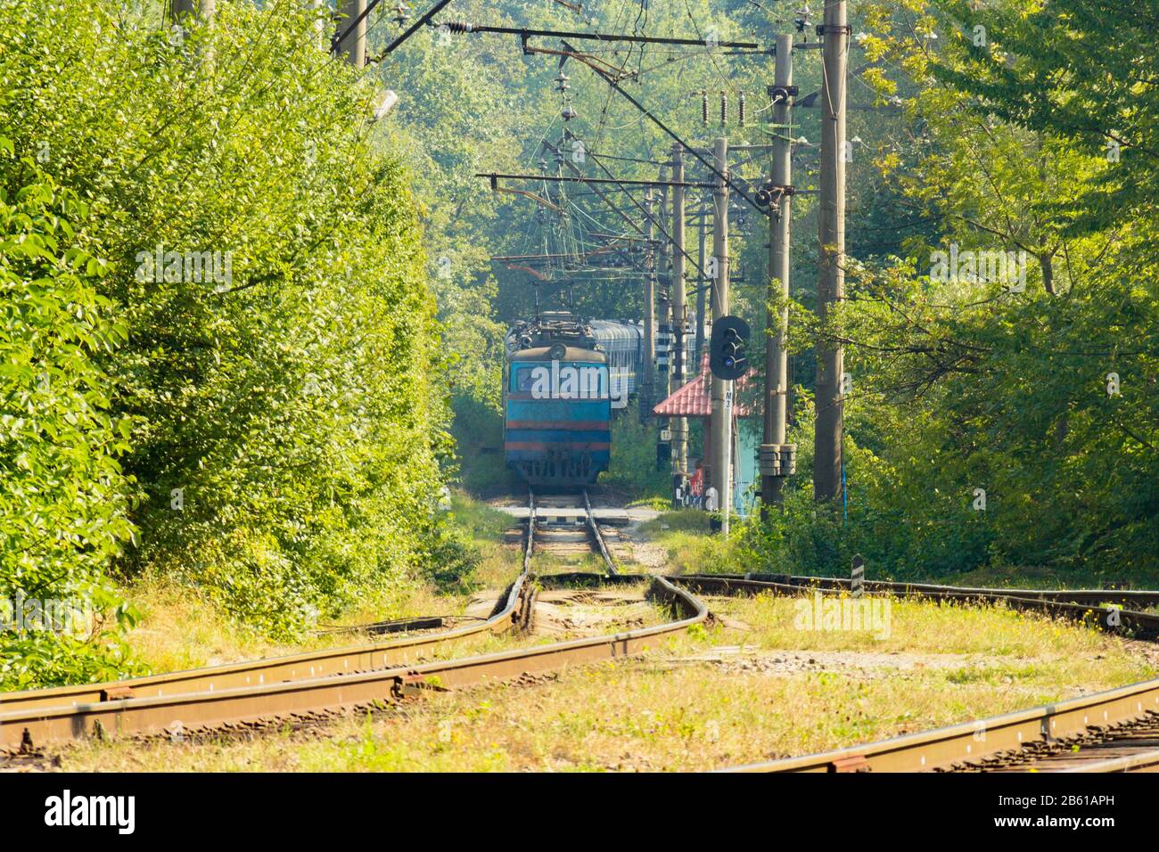 Old blue train is arriving at the platform at the railway station Stock ...