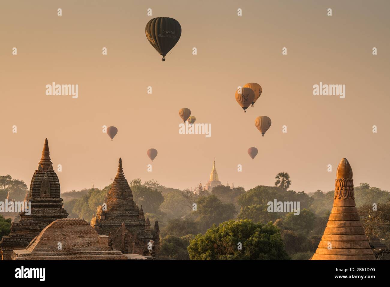 Bagans temples in sunrise with hot air balloons in the sky, Bagan ...