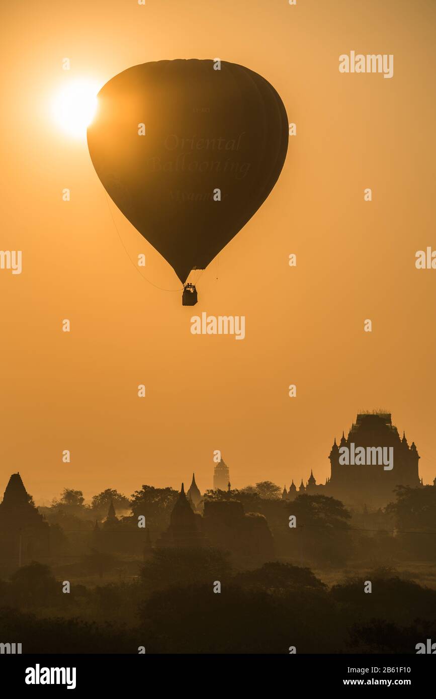 Bagans temples in sunrise with hot air balloons in the sky, Bagan ...