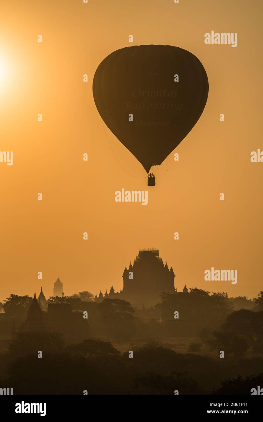 Bagans temples in sunrise with hot air balloons in the sky, Bagan ...