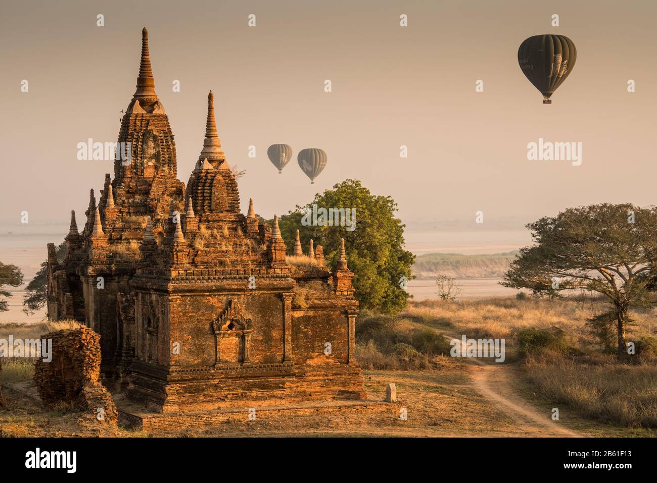 Bagans temples in sunrise with hot air balloons in the sky, Bagan ...