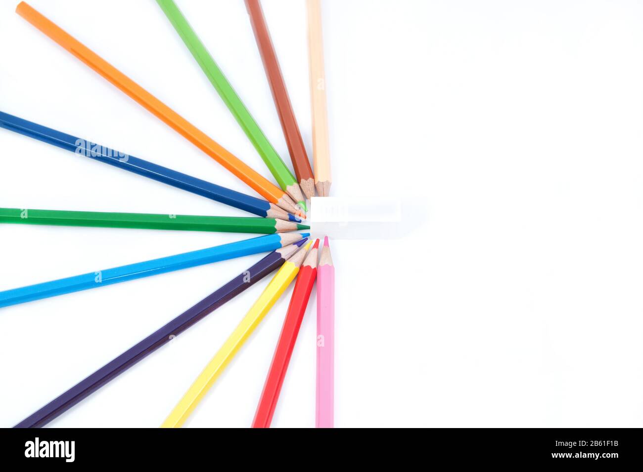 A set of colored pencils in the shape of half a star and eraser. On a ...