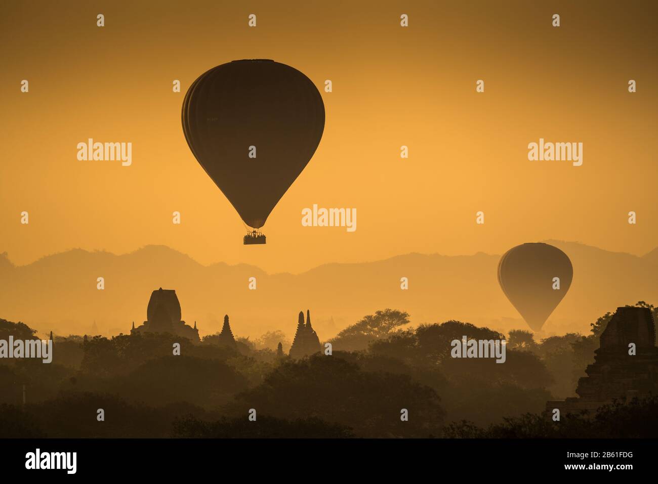 Bagans temples in sunrise with hot air balloons in the sky, Bagan ...