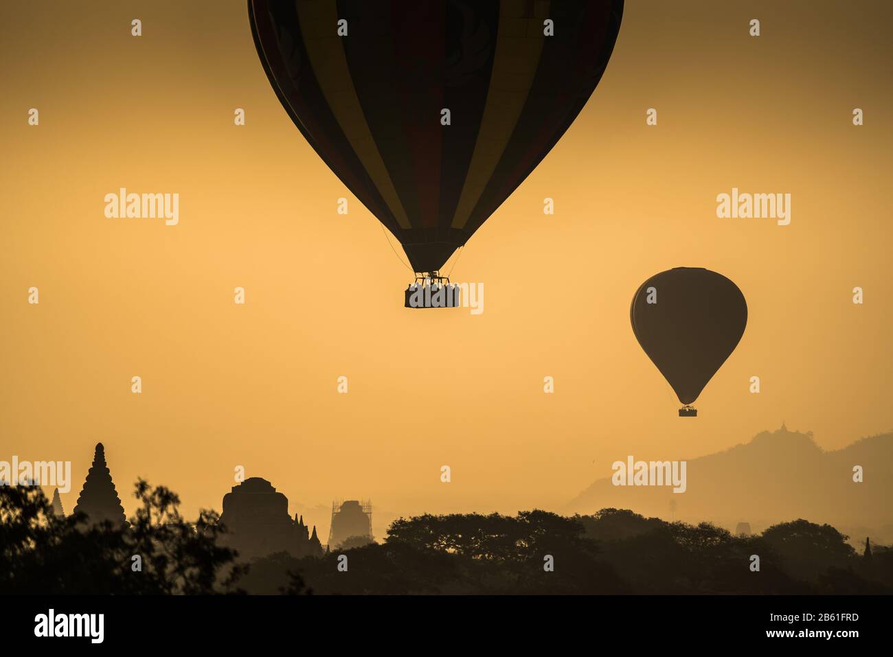Bagans temples in sunrise with hot air balloons in the sky, Bagan ...