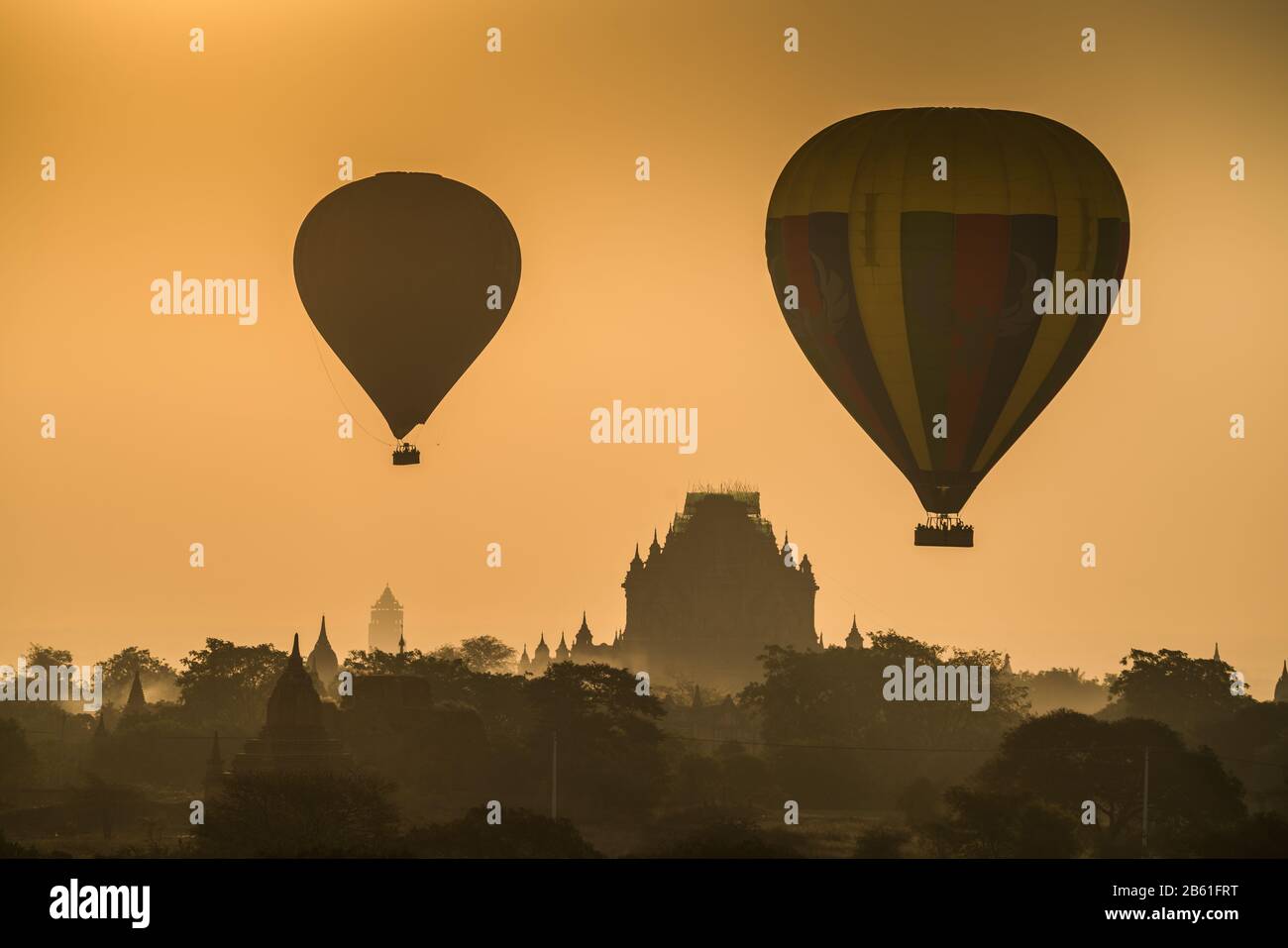 Bagans temples in sunrise with hot air balloons in the sky, Bagan ...