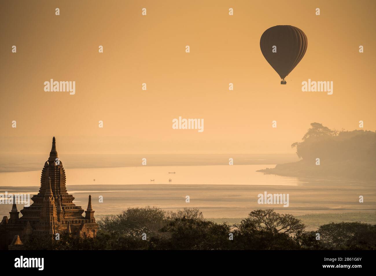 Bagans temples in sunrise with hot air balloons in the sky, Bagan ...