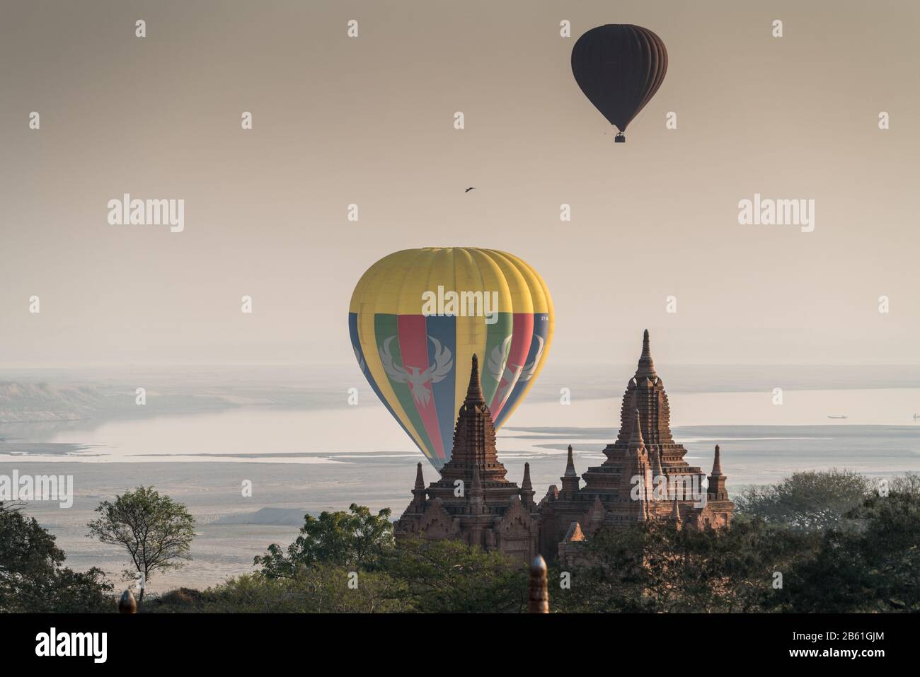 Bagans temples in sunrise with hot air balloons in the sky, Bagan ...
