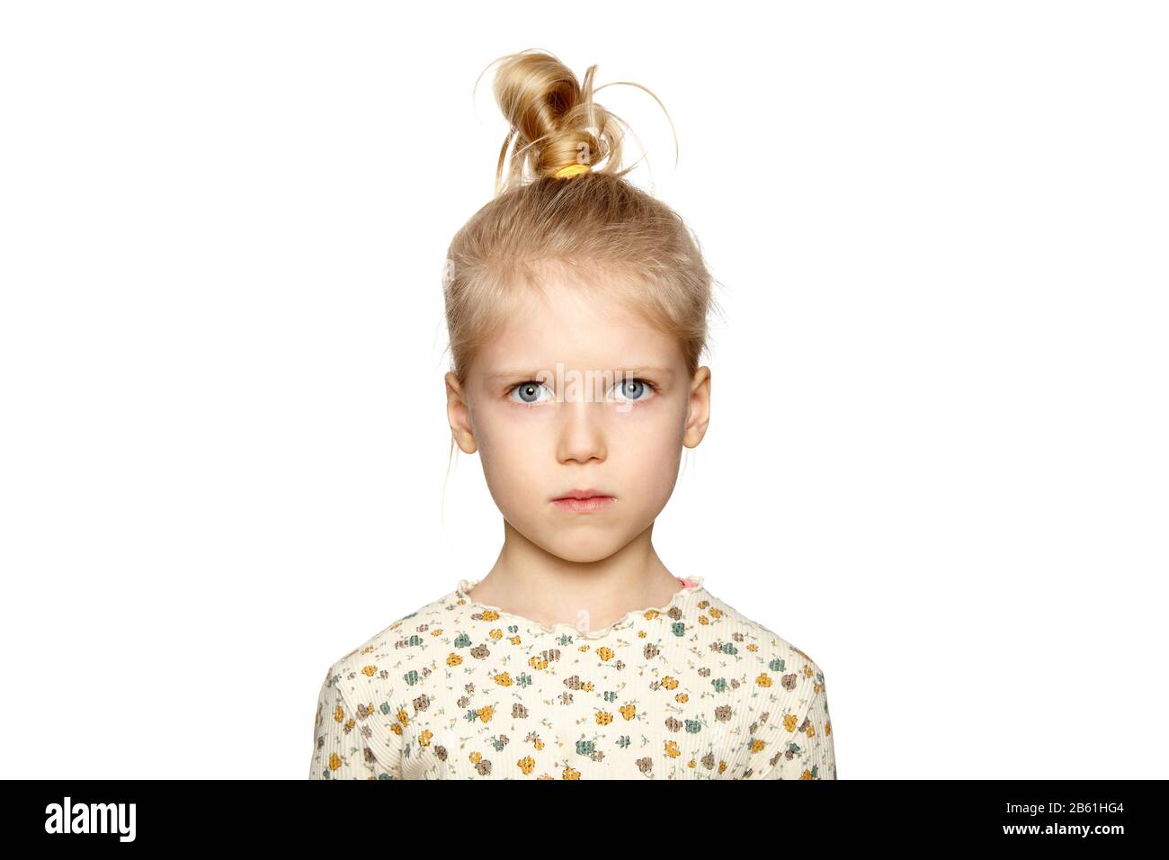 Photo of a pretty little girl with a serious expression Stock Photo - Alamy