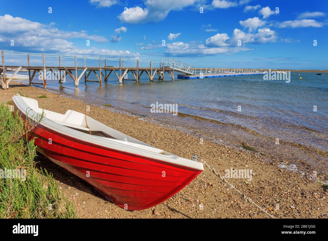 Red fishing boat on the shore. The sea Stock Photo - Alamy