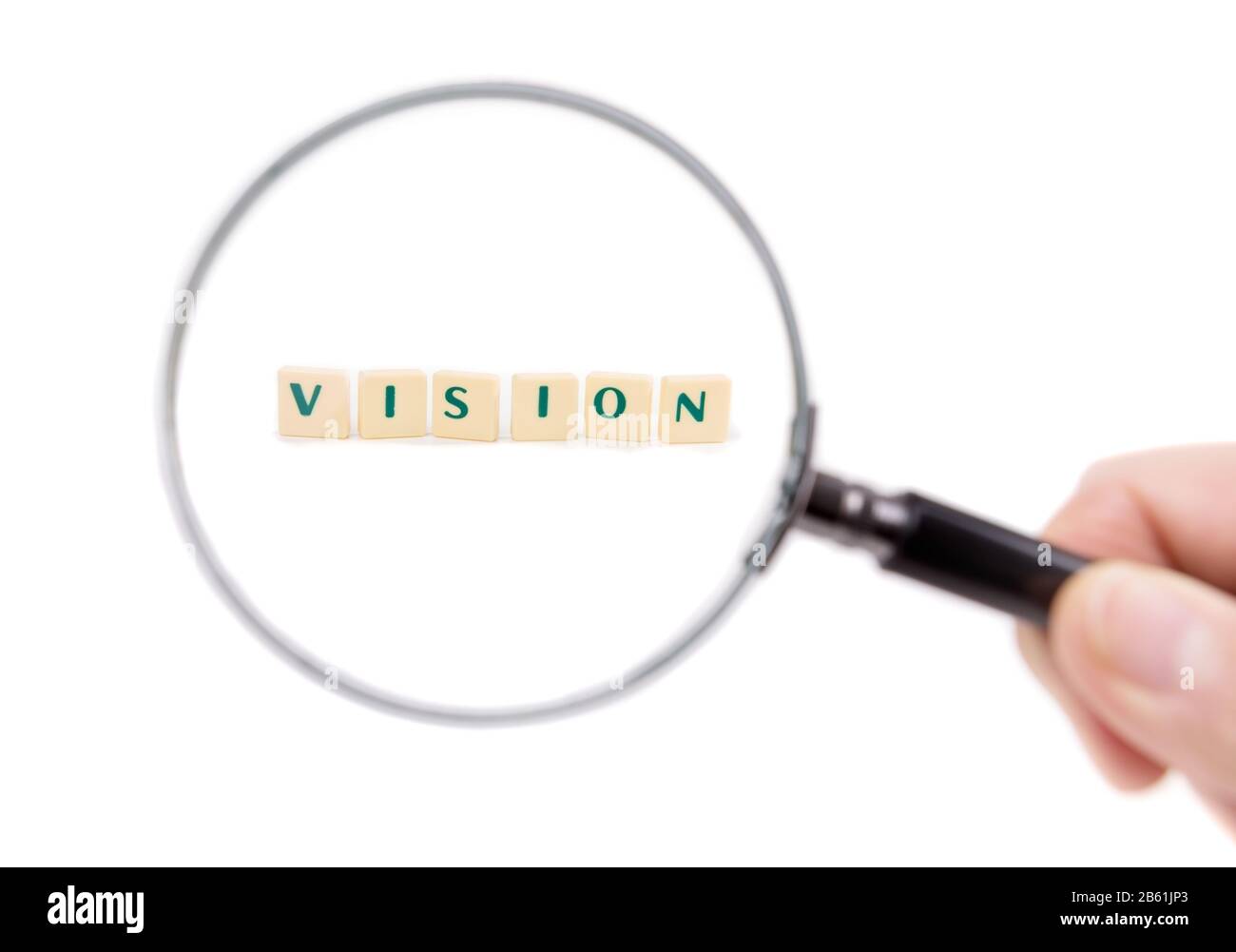 Magnifier enlarges the word vision. On a white background Stock Photo ...