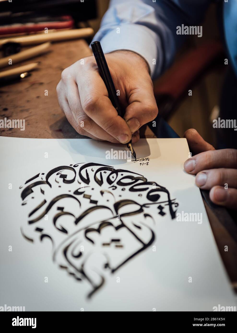 the traditional art and craftsmanship of calligraphy, an Arabian ...