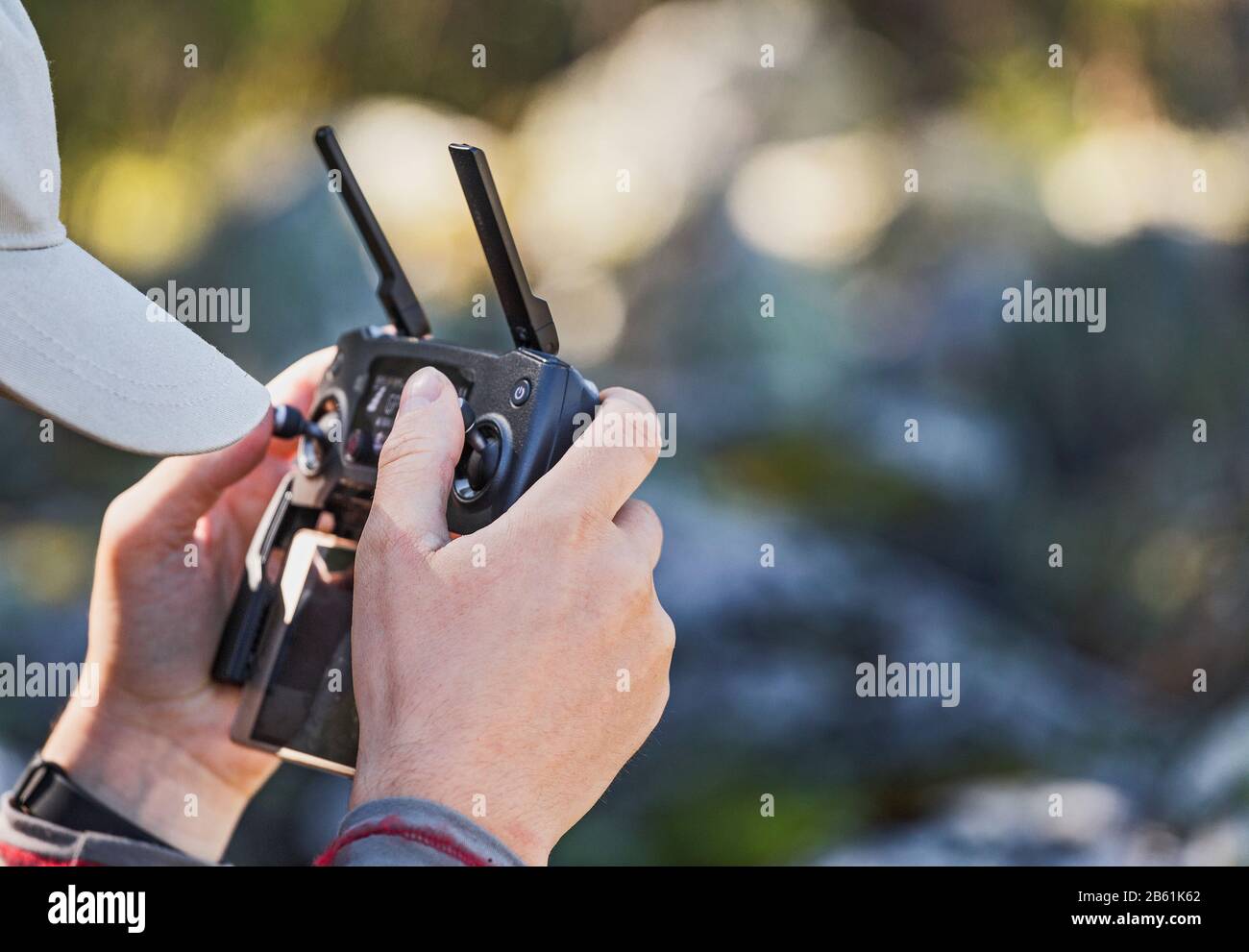closeup on male hands of drone operator with an amateur quadcopter ...