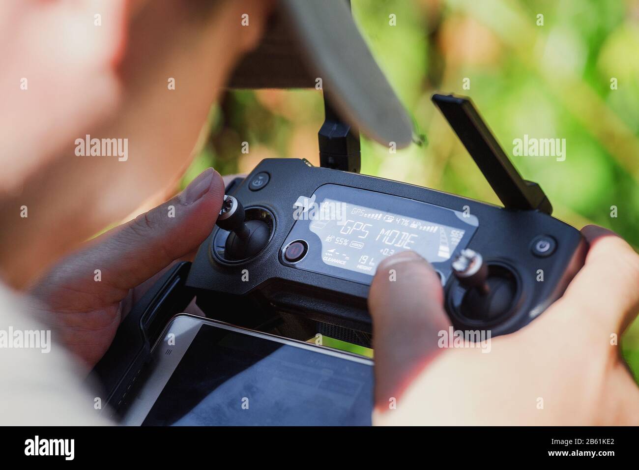 closeup on male hands of drone operator with an amateur quadcopter ...
