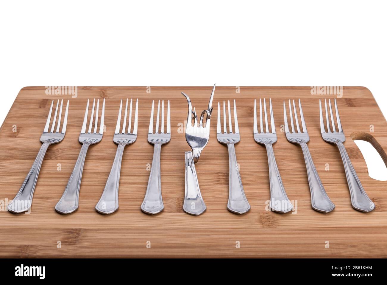 Abstraction of the kitchen forks and one fork bending. Individualism ...