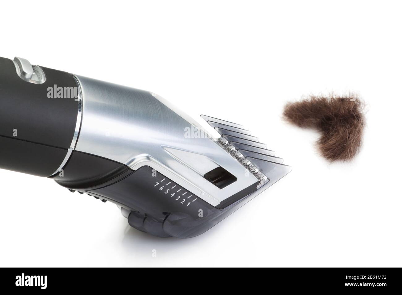 Modern hair clipper. Lump of hair Stock Photo - Alamy