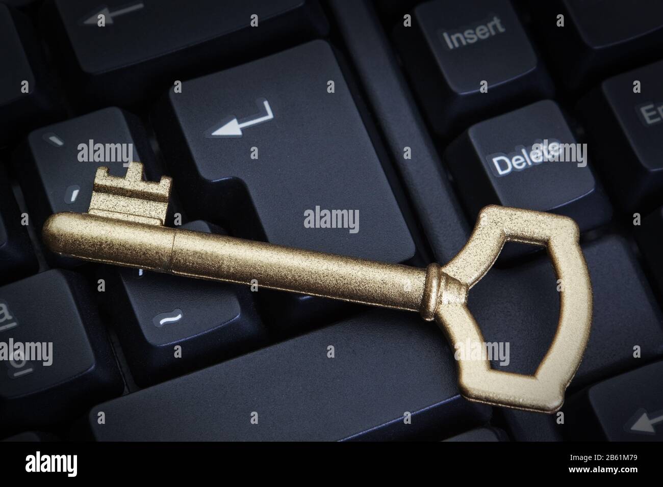 Golden key on the keyboard symbol of safety and protection Stock Photo ...