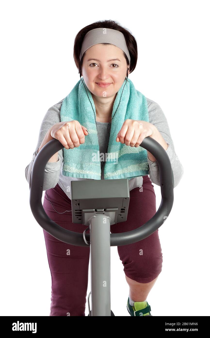 Fat woman loses weight herding fat on a stationary bike. On a white ...