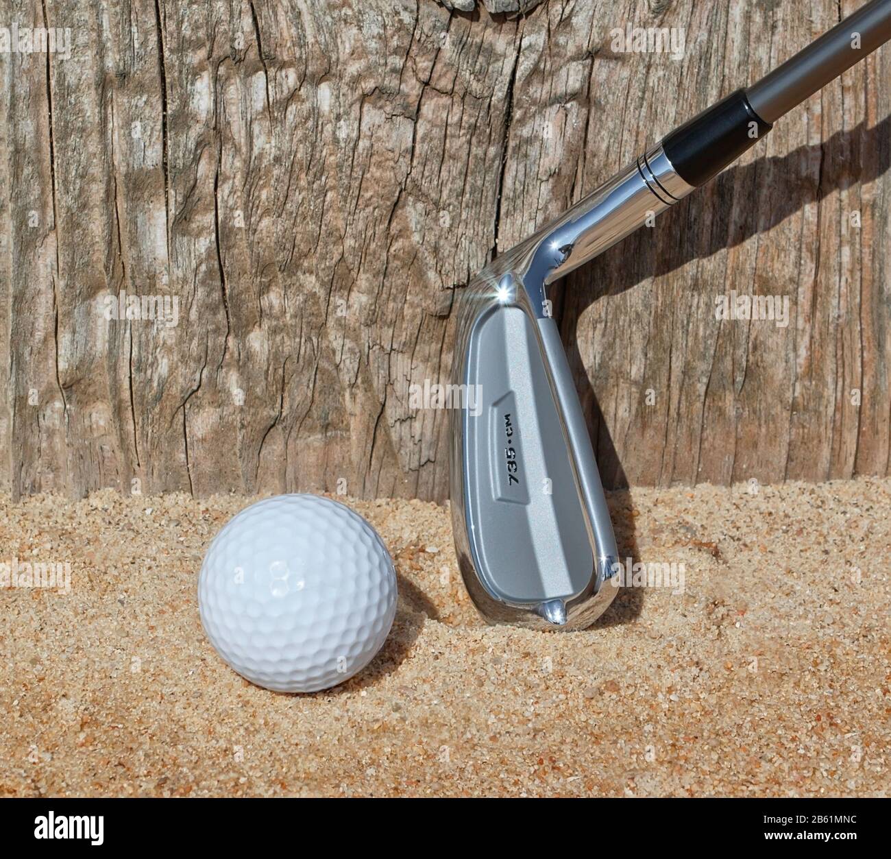 Golf ball and stick inverted wooden support in the sand. Close-up Stock ...
