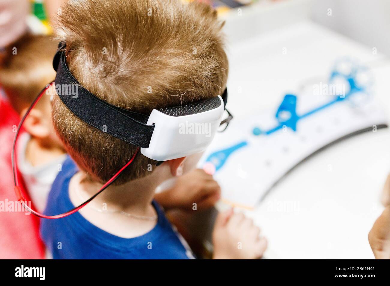 Child with the sensor device on the head doing mental and brain ...