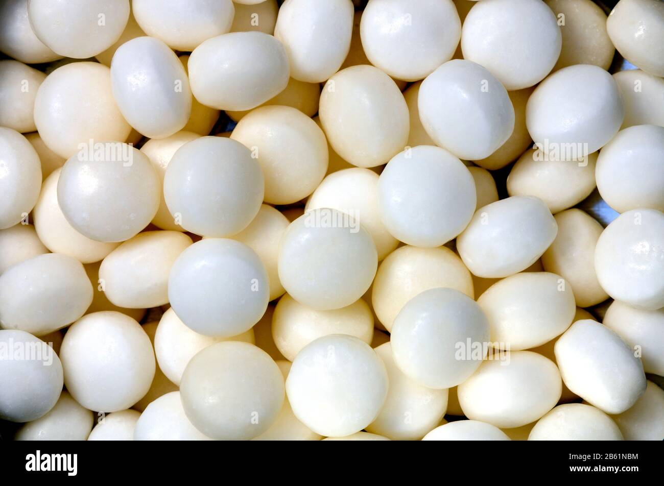 Plenty of little white sugar coated tablets Stock Photo - Alamy