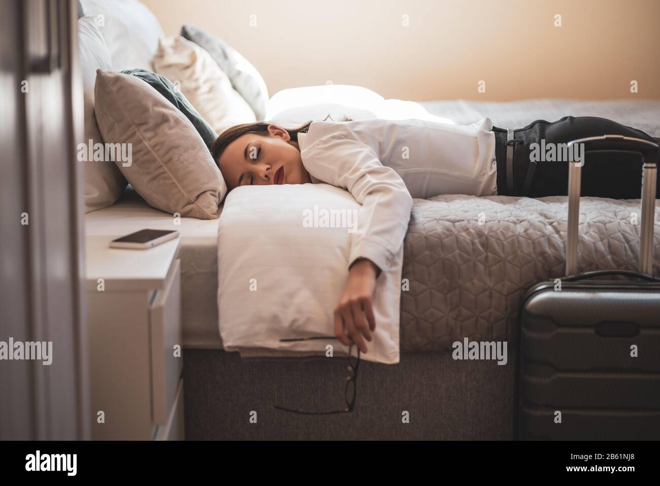 Tired businesswoman is sleeping dressed in hotel room Stock Photo - Alamy