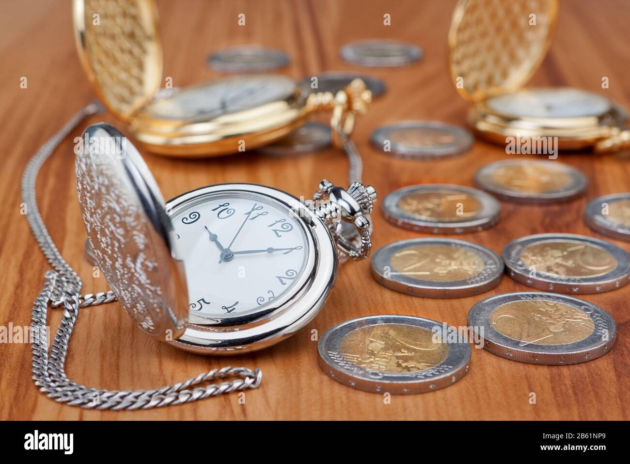 Silver pocket watch with silver coins hi-res stock photography and ...