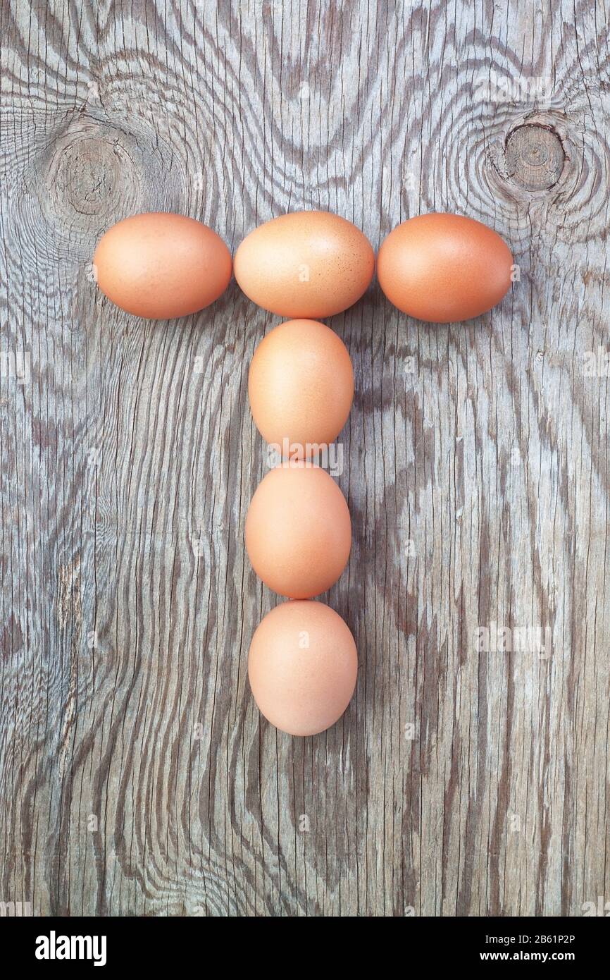 A letter t from the eggs for Easter. On a wooden texture Stock Photo ...