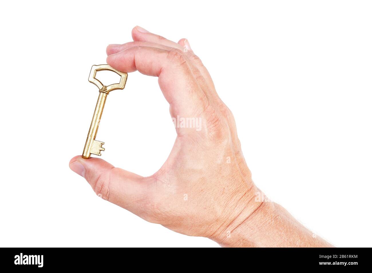 Golden key in hand symbol of the rich house. On a white background ...