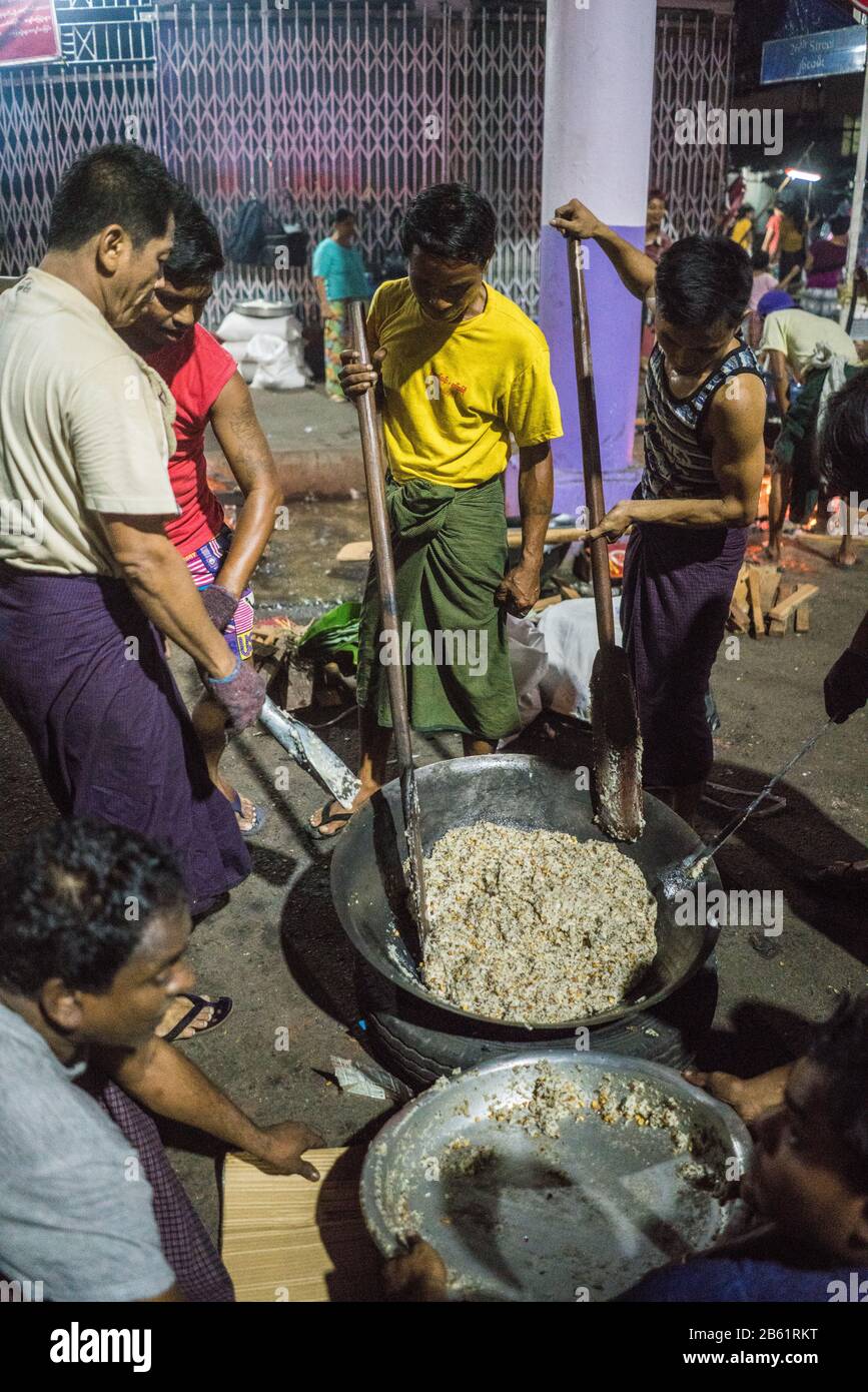 Local men cook food in the street of the Yangon, Myanmar, Asia Stock ...