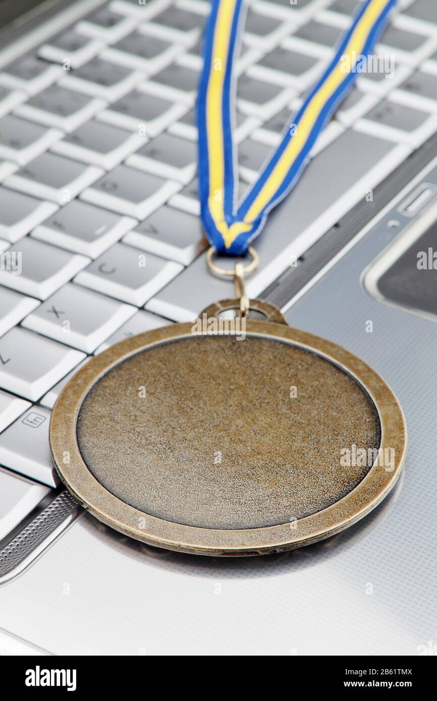 Modern laptop and award a gold medal for success. Close-up Stock Photo ...